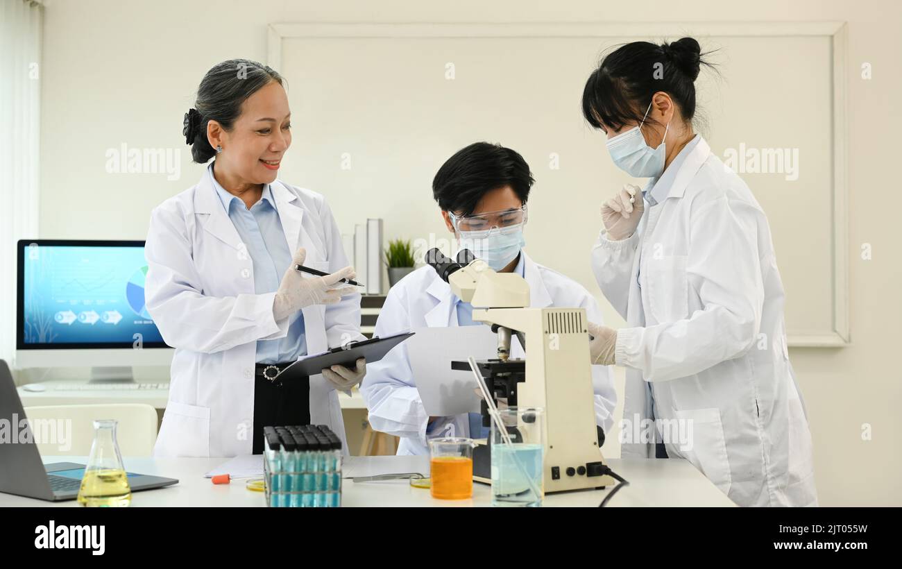 Senior female supervisor and young biotechnology specialist scientists ...