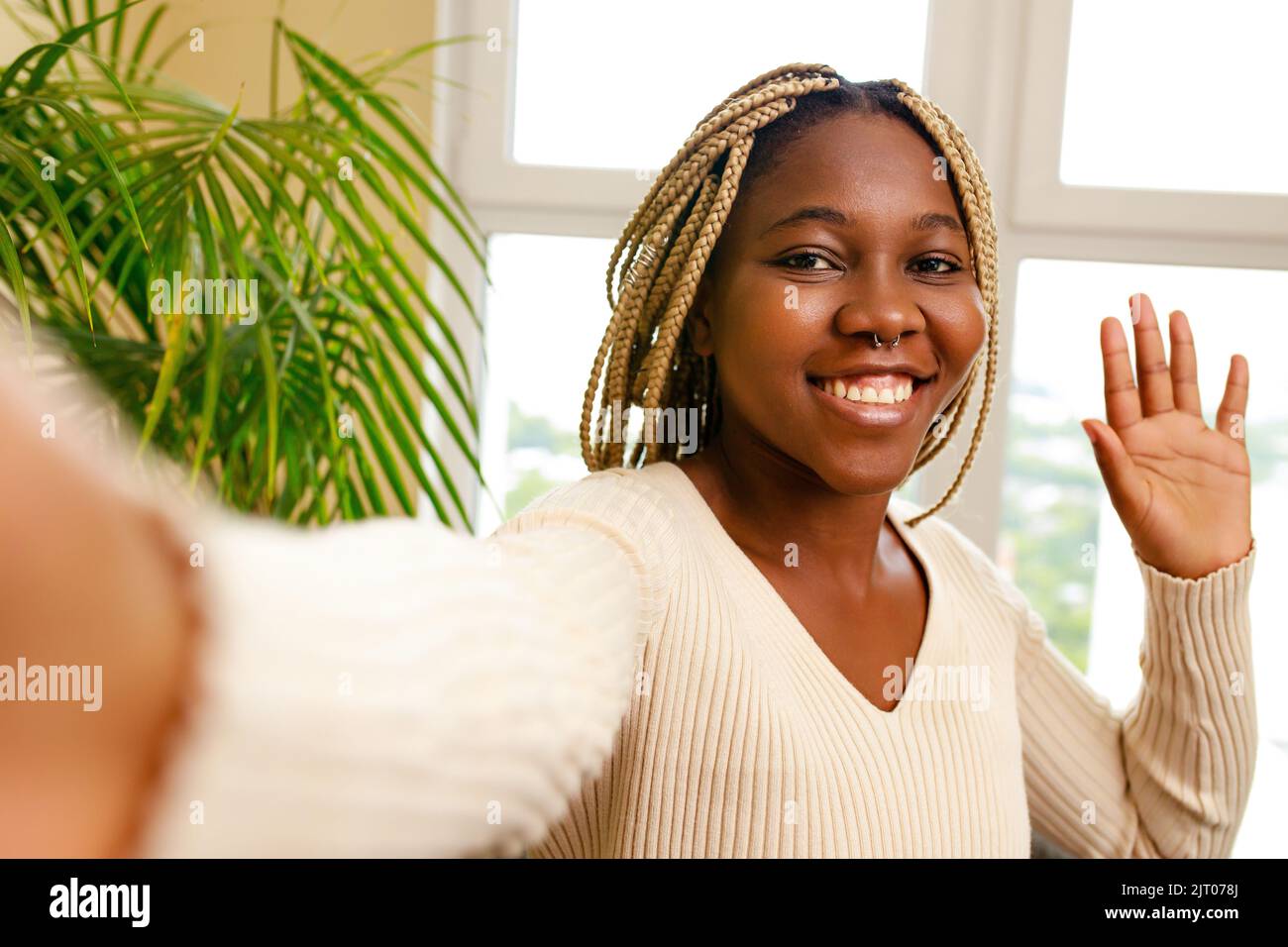 afro american woman waving hand greeting by video call at home Stock ...