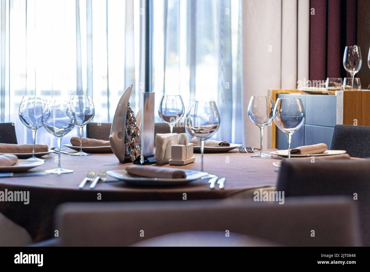 an empty table with dishes in a cafe or restaurant against the backdrop ...