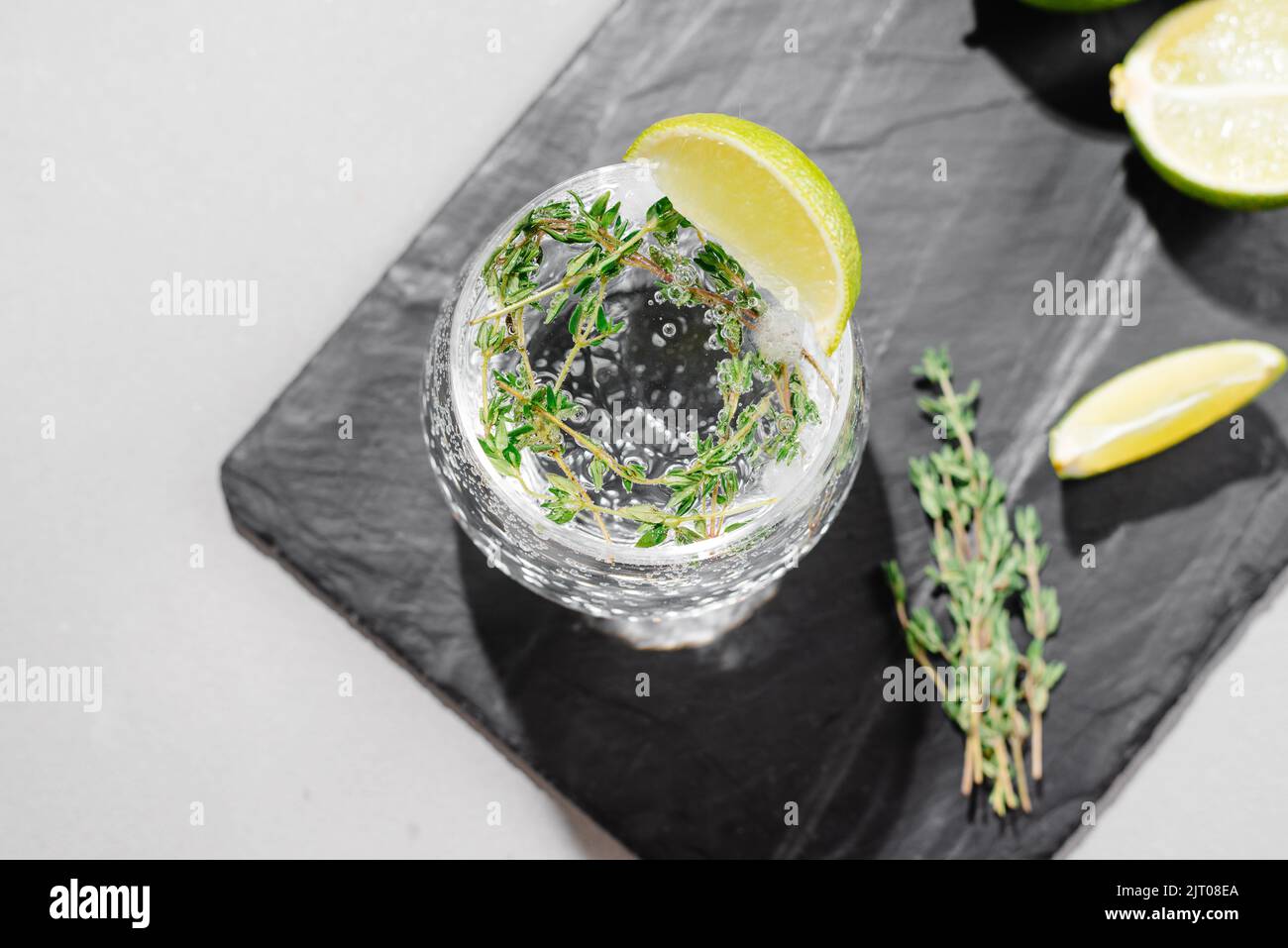 Alcoholic beverage with tonic and lime view from above. Background gray ...