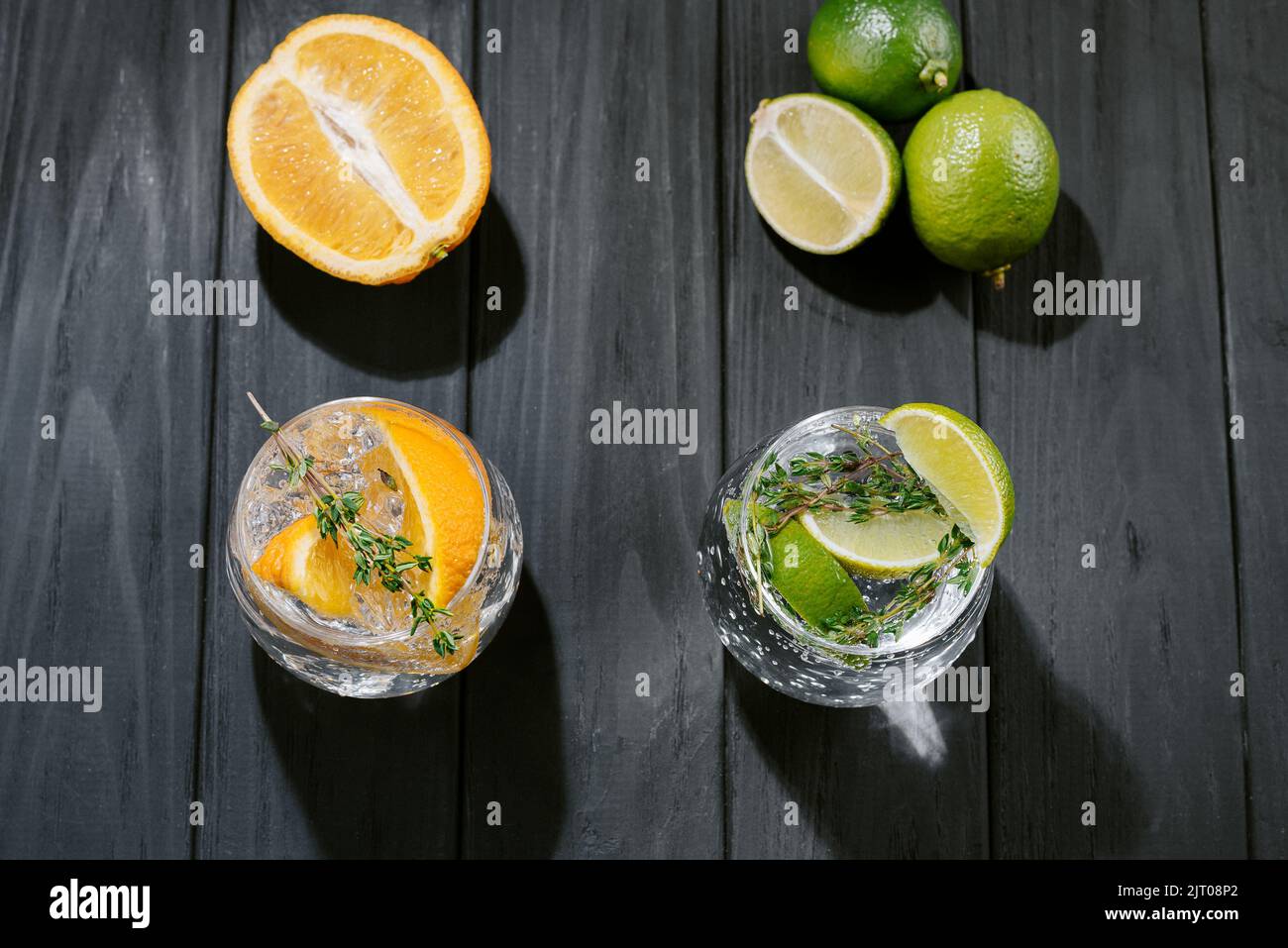 two glasses with an alcoholic cocktail on a wooden dark background ...