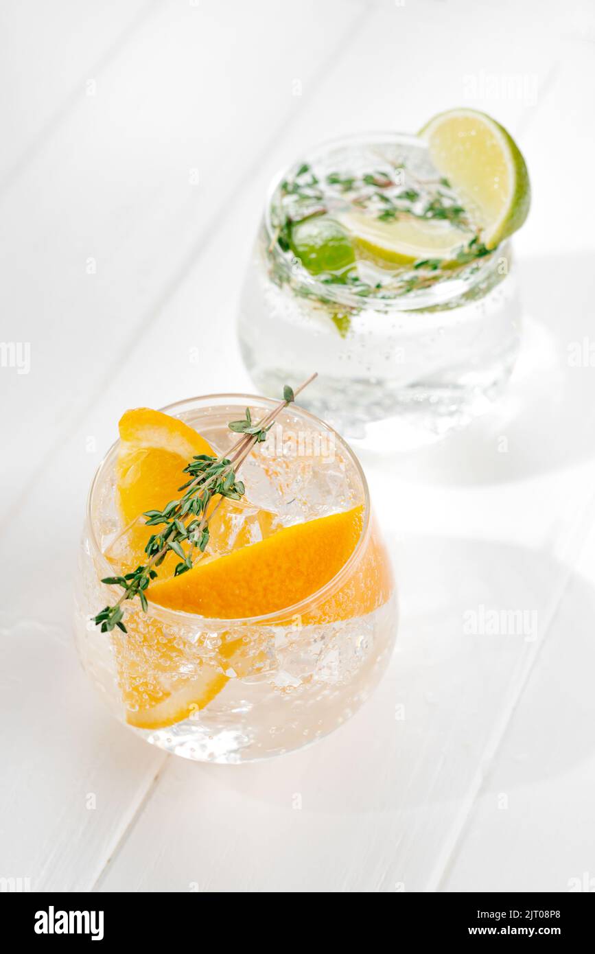 two glasses with an alcoholic cocktail on a light background. hard ...
