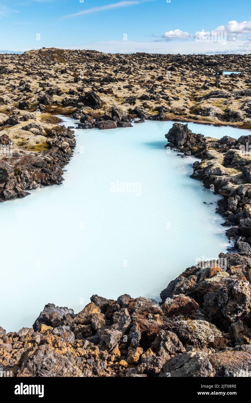 The milky blue waters from the geothermal power station that feed into ...