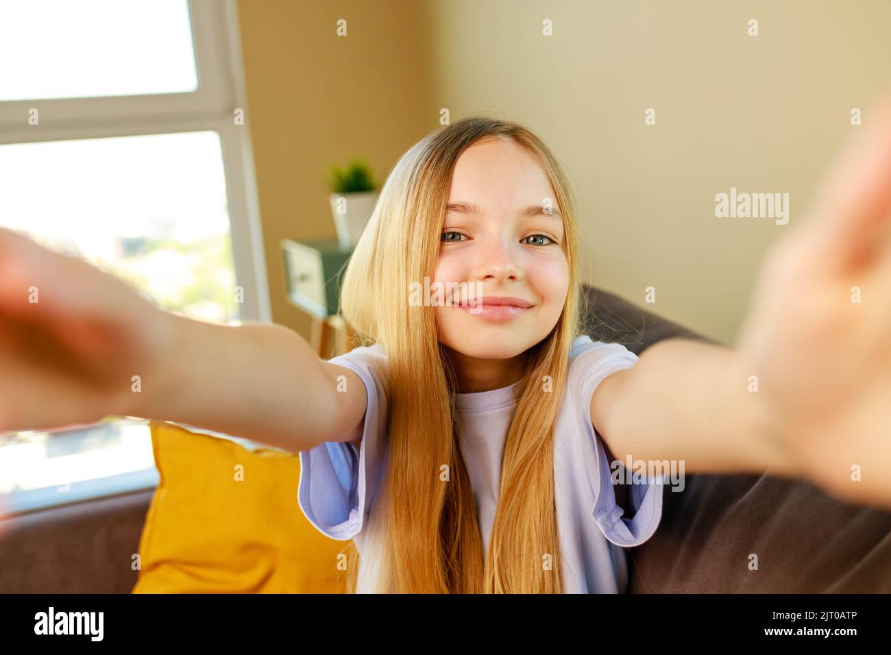 pre-teen girl making selfie photos on her smartphone in cozy living ...