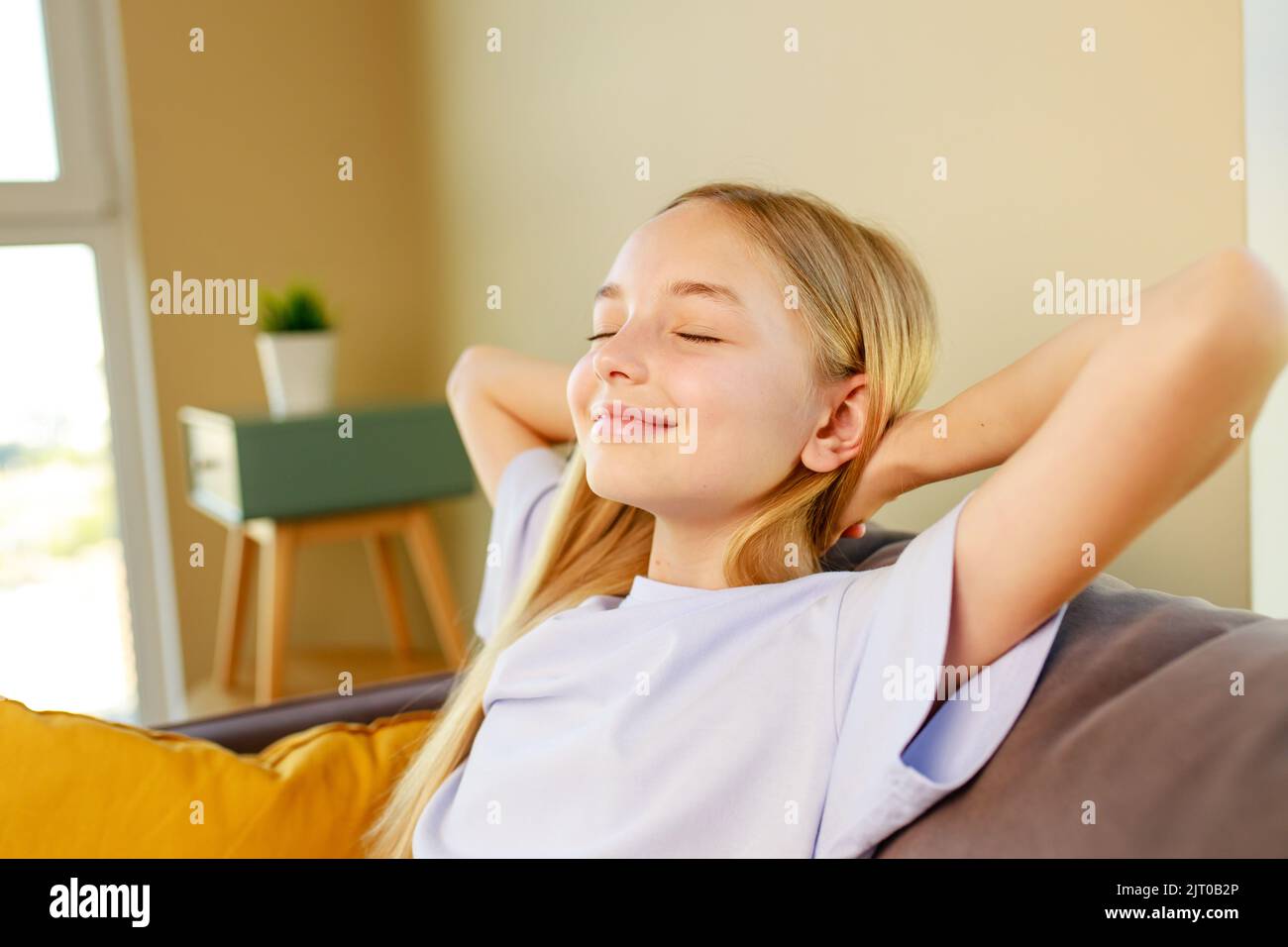 little cute girl sleeping on sofa after study in school daytime Stock ...