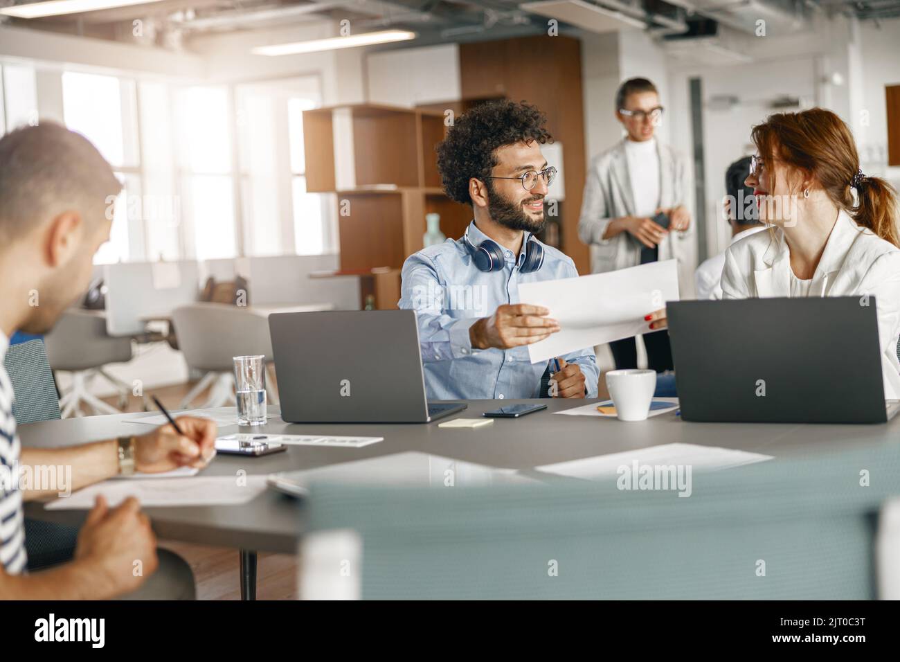 Busy coworkers cooperating and working together at office meeting ...