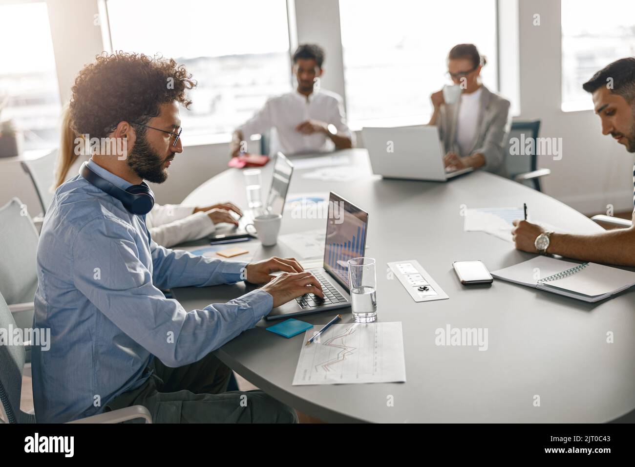 Busy coworkers cooperating and working together at office meeting ...