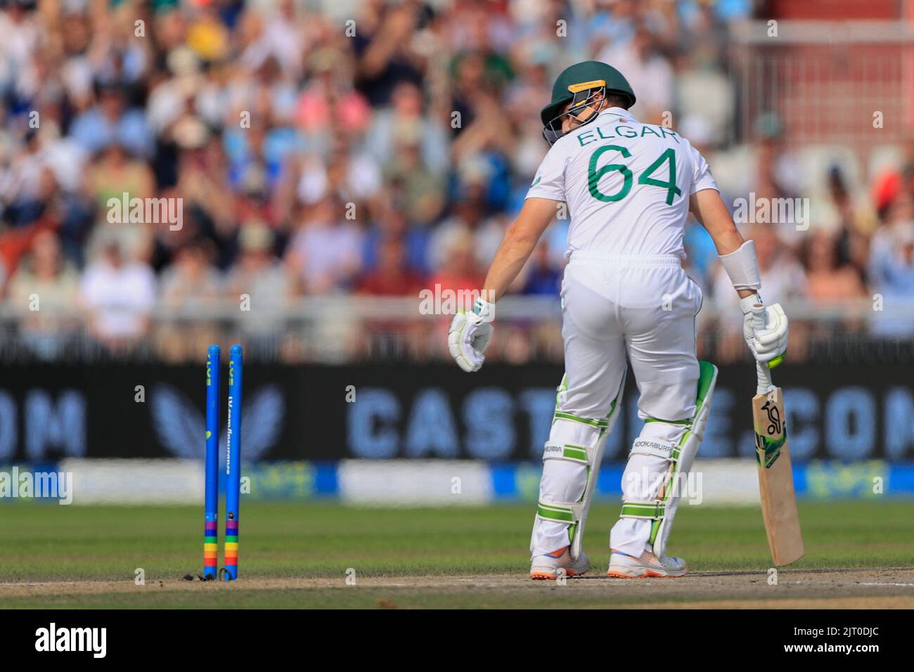 Dean Elgar of South Africa looks back at his missing stump as he is ...