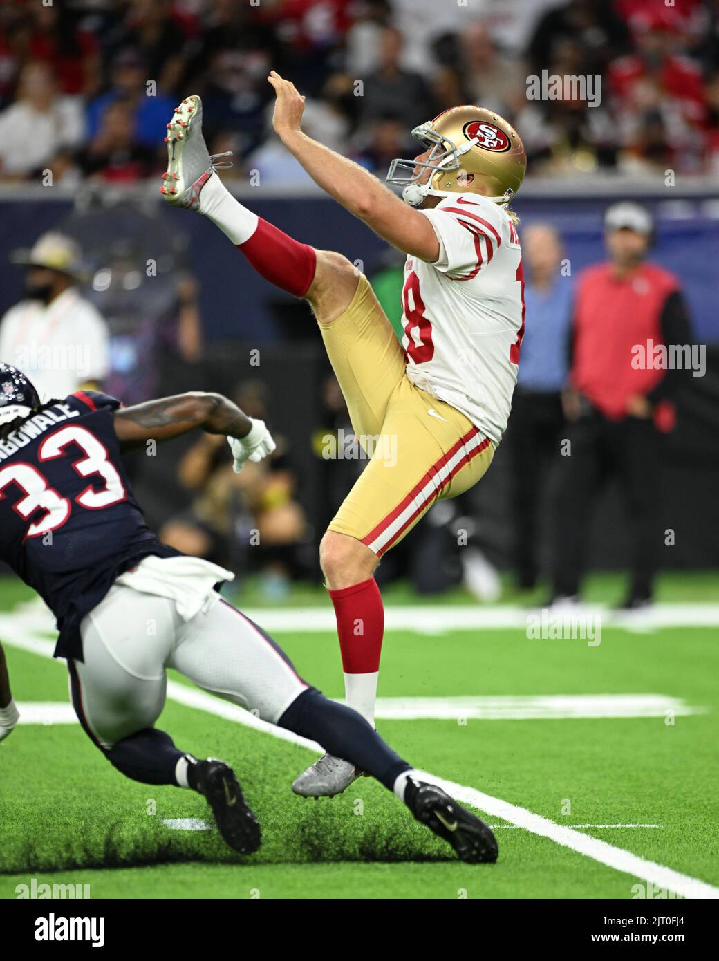 San Francisco 49ers punter Mitch Wishnowsky (18) punts under pressure ...