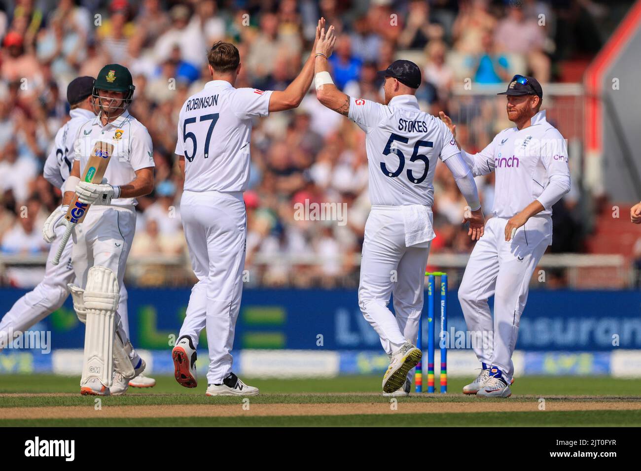 Ollie Robinson of England and Ben Stokes of England celebrate the fall ...