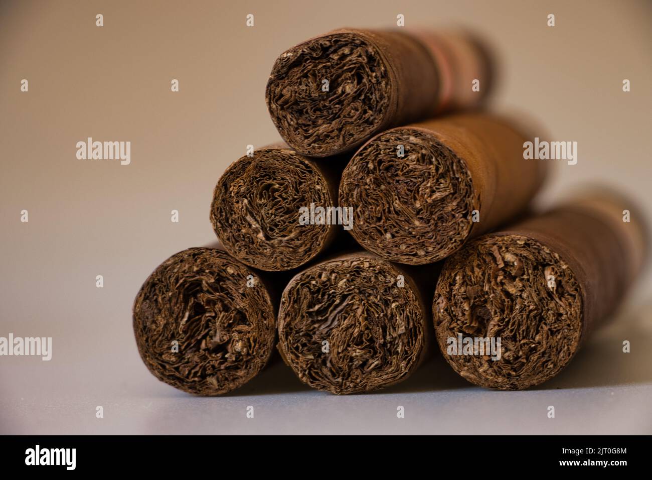 A pyramid stack of six Cuban cigars on the white background Stock Photo ...