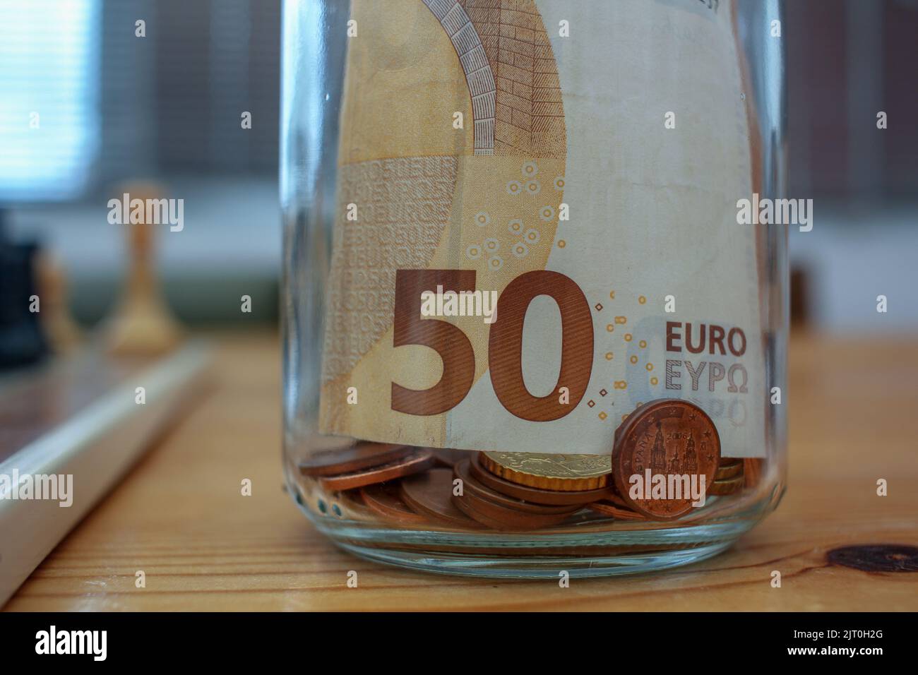 euros from last month tips in a glass jar Stock Photo - Alamy