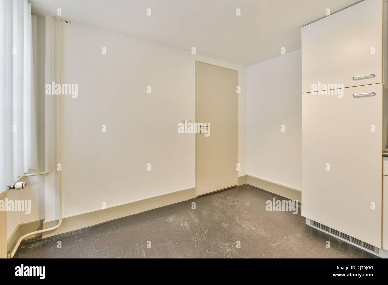 Interior of empty white kitchen with windows and wooden parquet floor ...