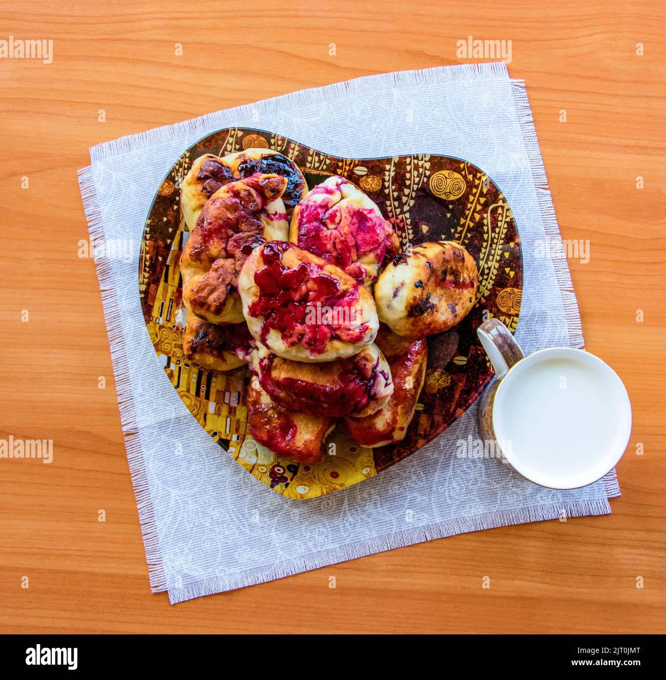 a berry pie fried in a frying pan in oil with cherries on a saucer and ...