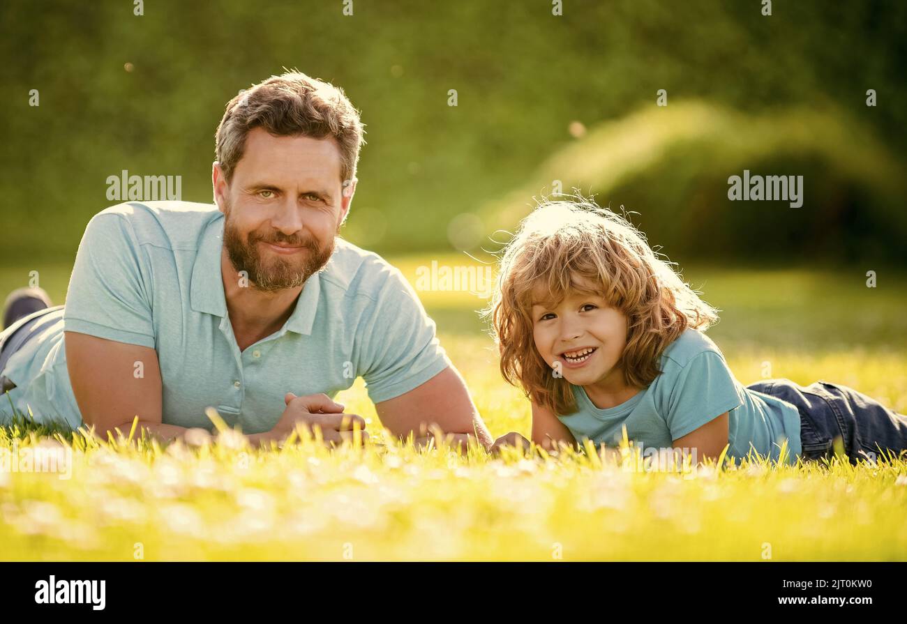 happy family portrait of father and son kid relax in summer park green ...