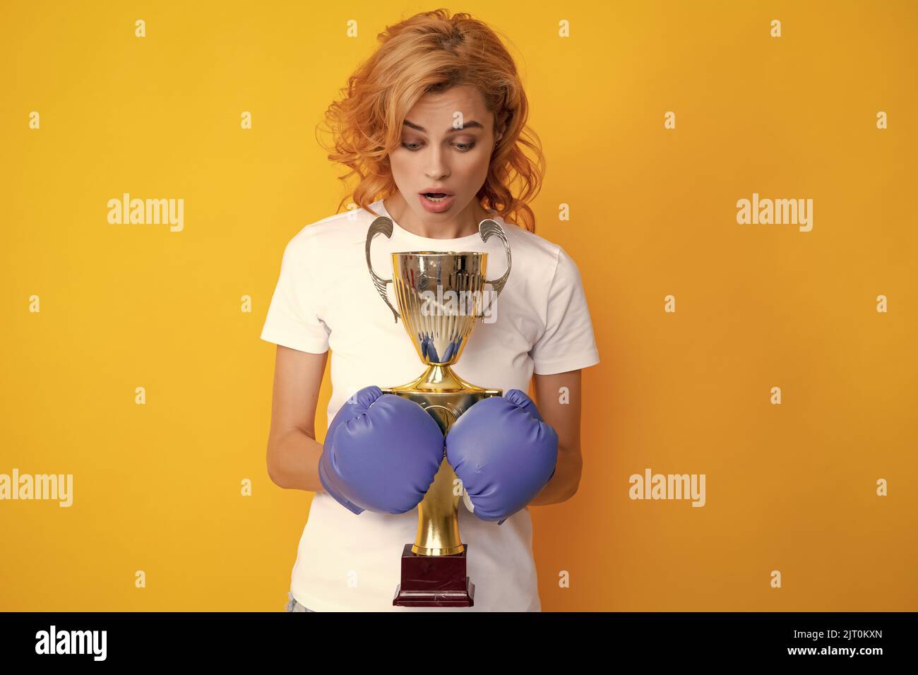 Portrait of funny surprised winner woman in boxing gloves isolated on ...