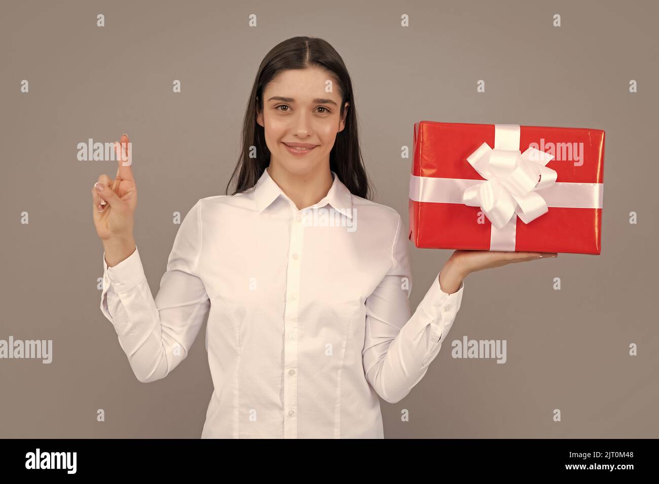 Happy birthday. Funny girl crossed fingers for good luck. Woman holding ...