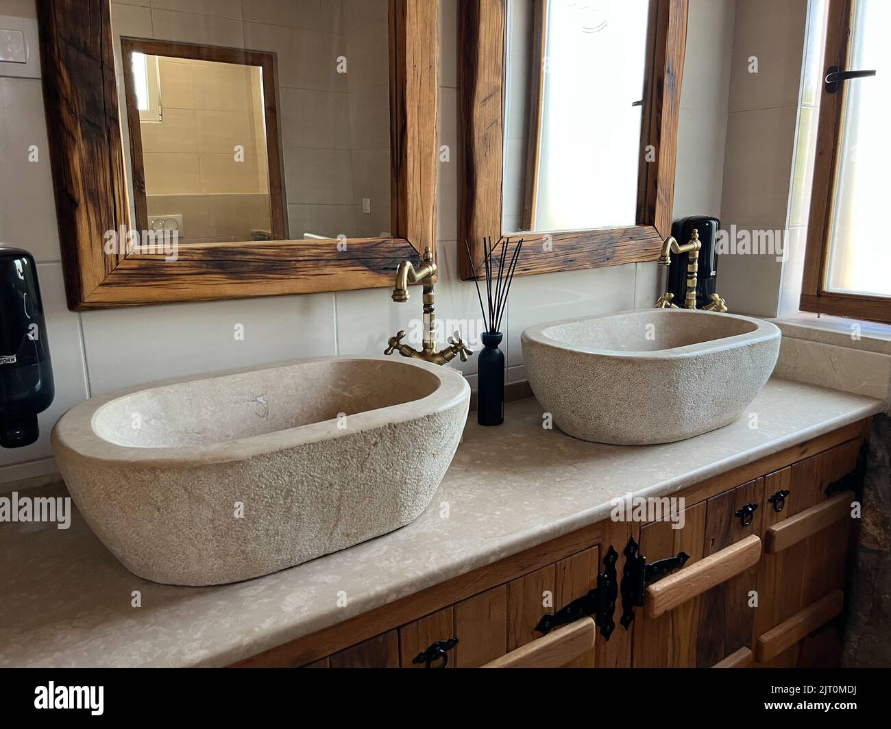 Bronze faucets over stone wash basins in the bathroom Stock Photo - Alamy