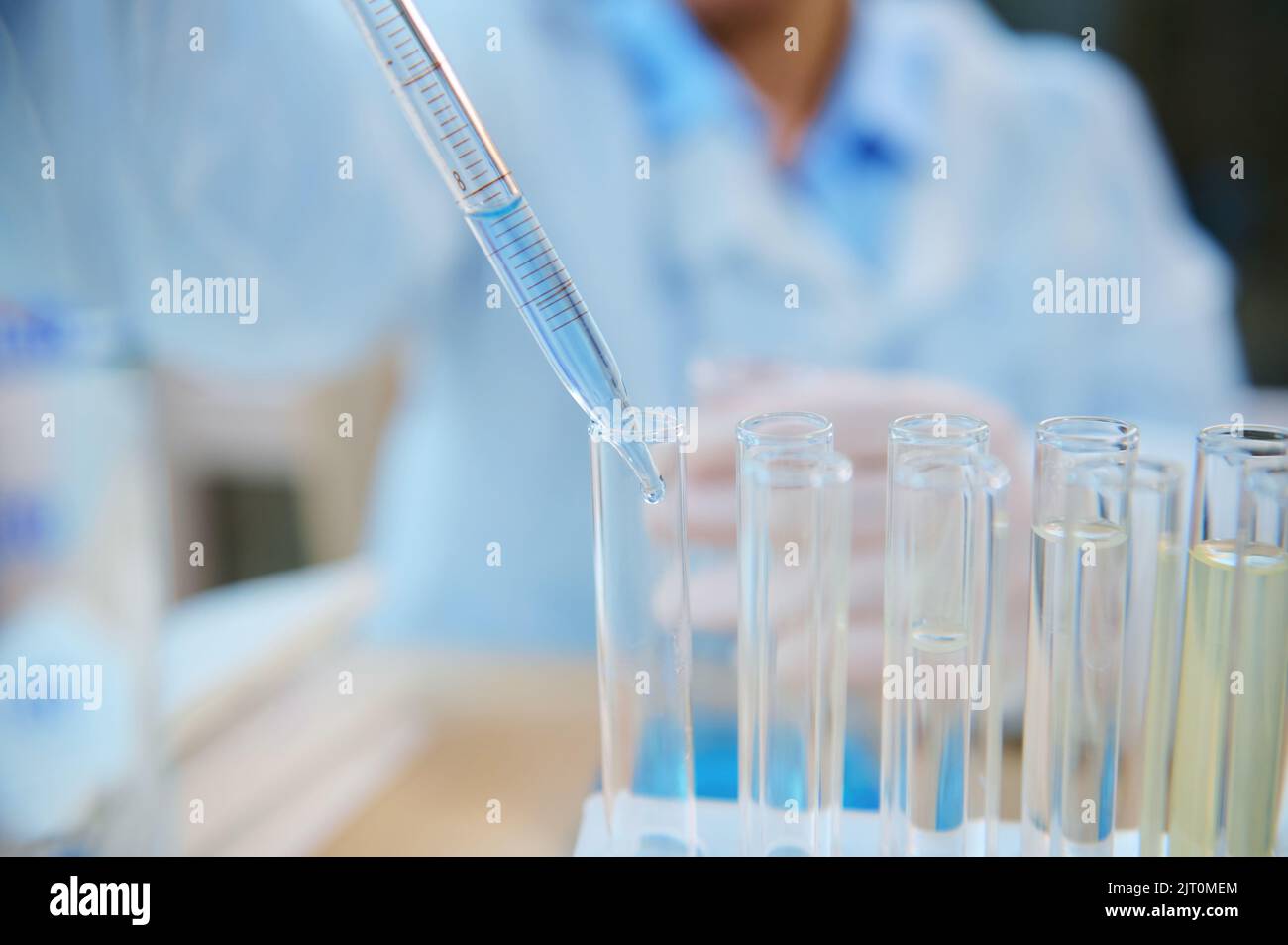Details: Dripping reagent into test tube. Pharmacologist conducts ...