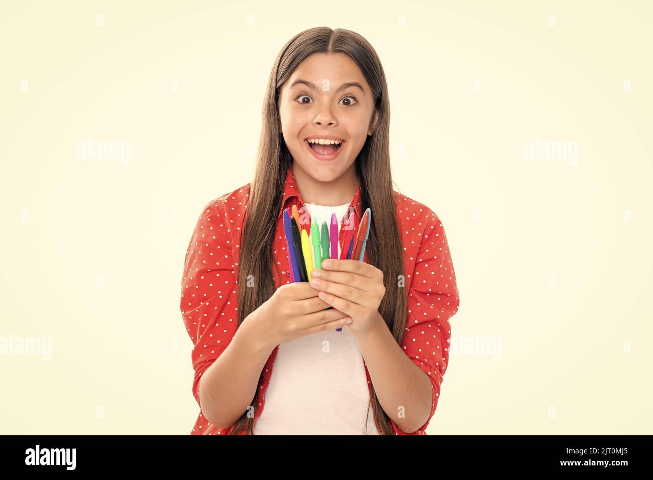 Portrait of excited teenager school girl with colorful pencils isolated ...