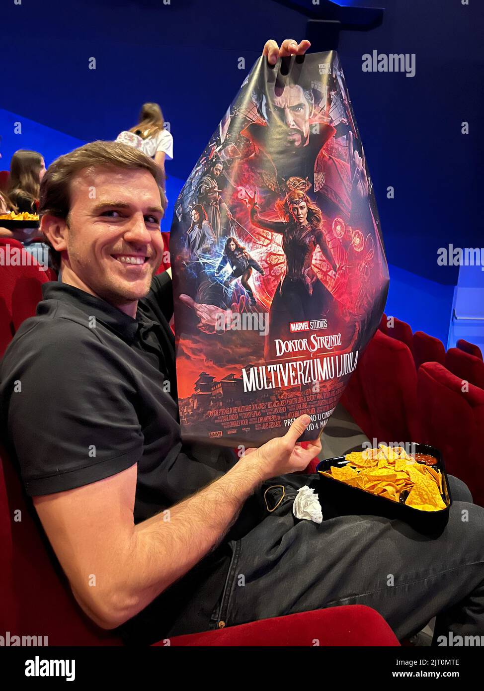 Podgorica, Montenegro - 25.08.22: Man in a cinema with a poster for the ...