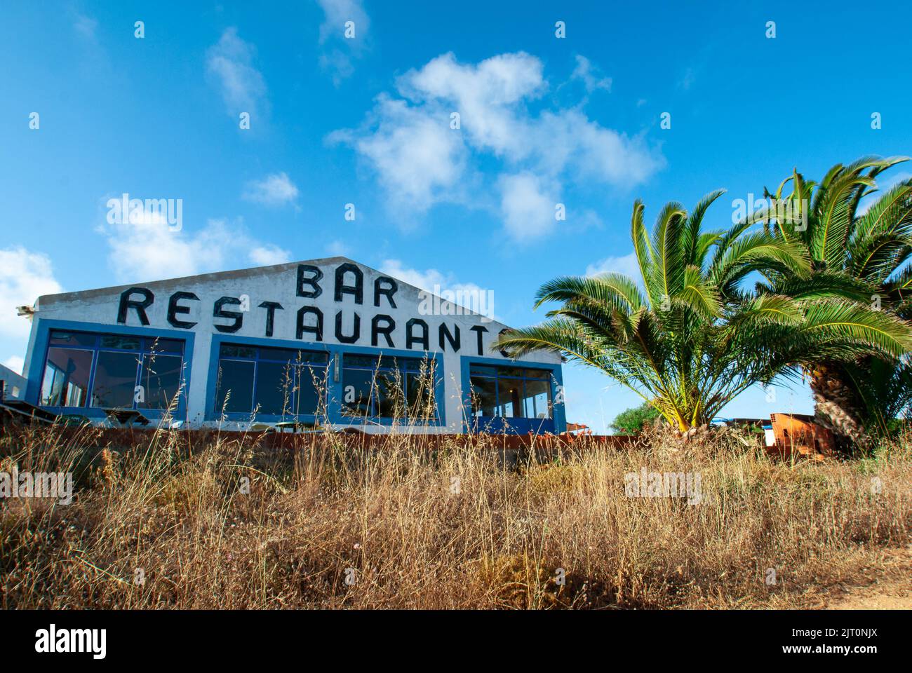 A bar restaurant with long grass and trees Stock Photo - Alamy