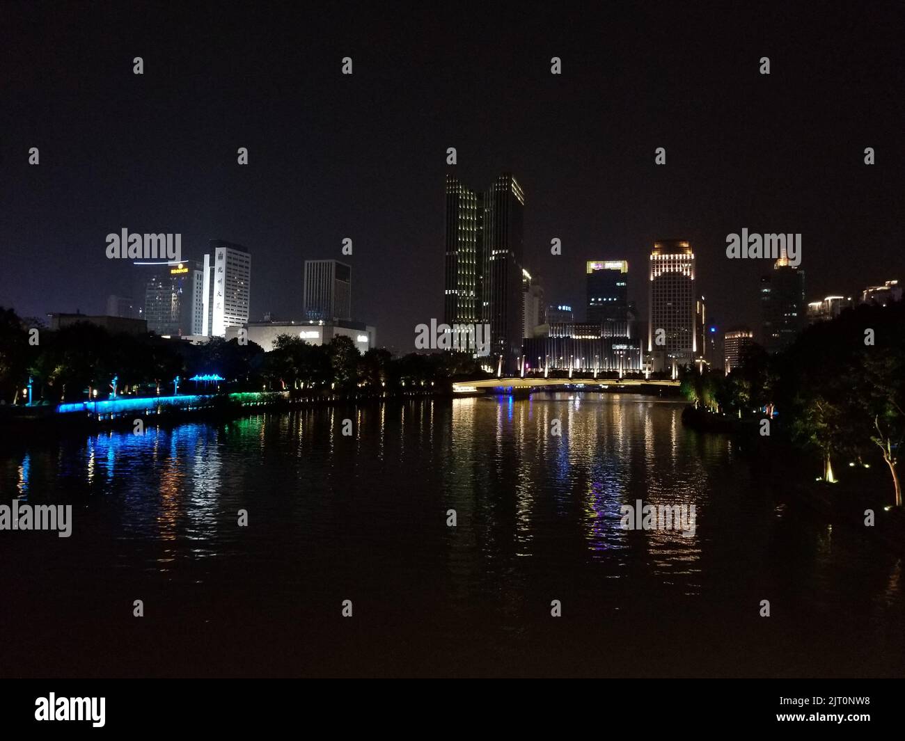 The view of Hangzhou at night with lights reflection in the lake. China ...