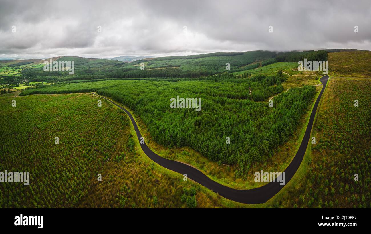 An aerial view of white fluffy clouds over scenic green valley, Ireland ...
