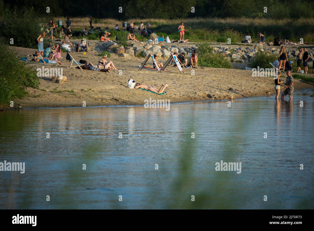 People are seen relaxing on a beach in bathing suits on the Vistula ...
