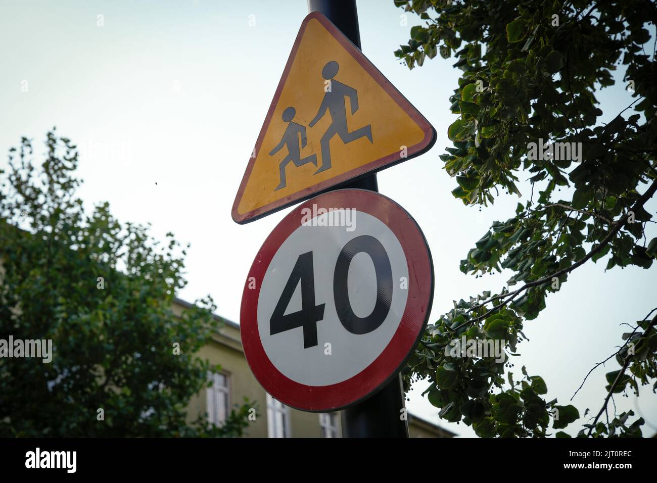 A traffic sign warning drivers to slow down at a school children's ...