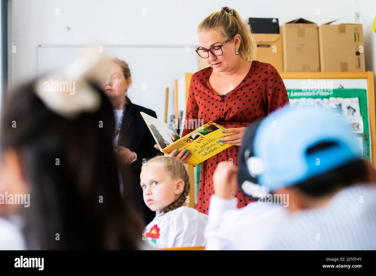 27 August 2022, Berlin: Ulrike Möwes, teacher of class 1C, reads from a ...