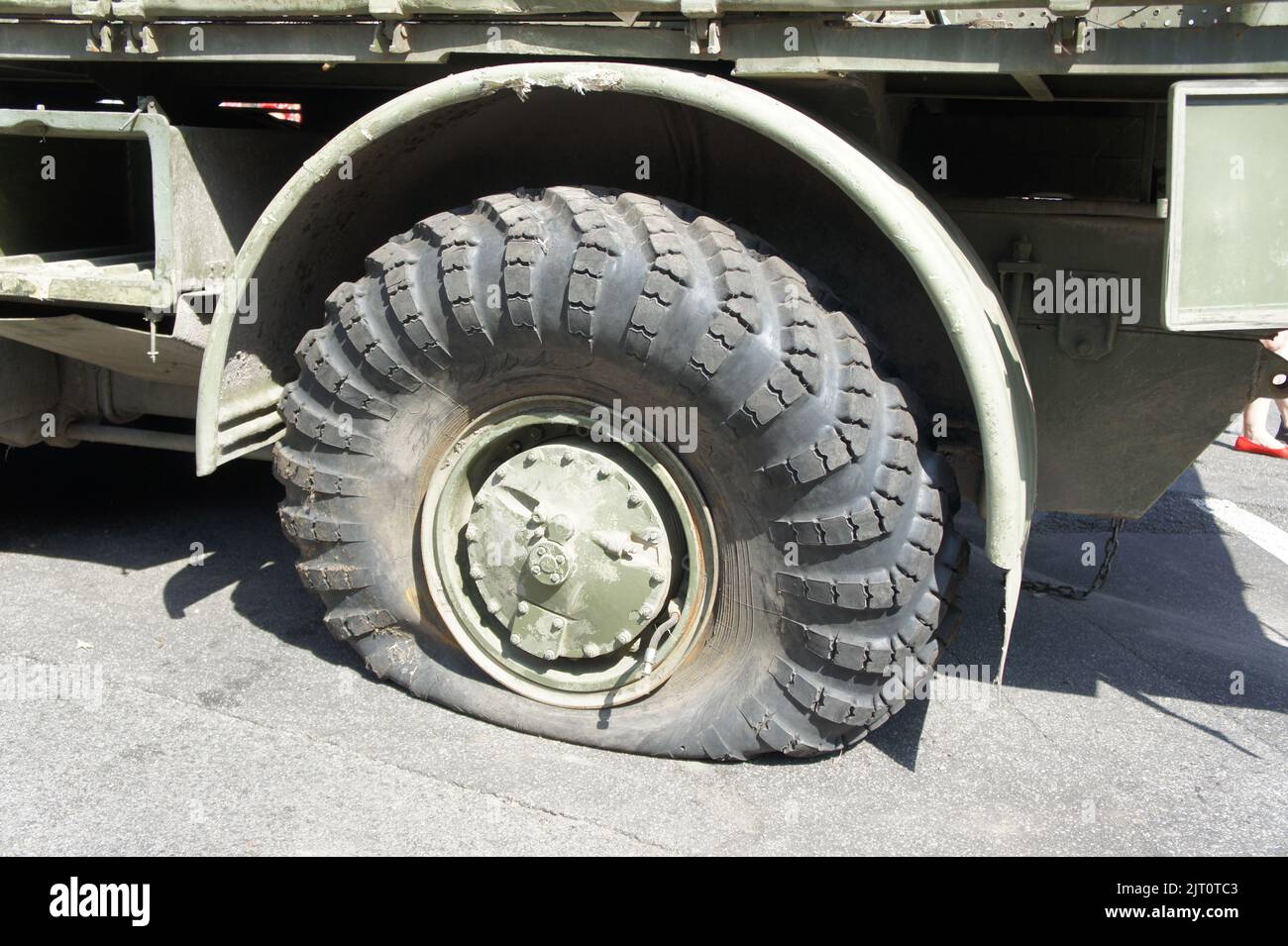 A punctured and flat tire of military equipment of the armored ...