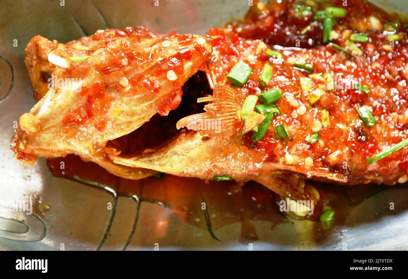 deep fried red banded grouper fish dressing sweet chili sauce on plate ...