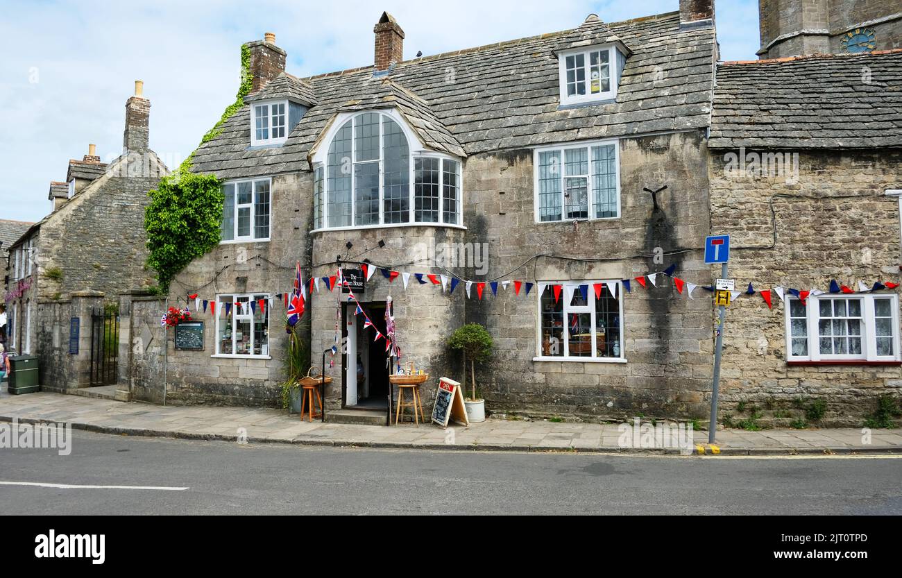 Exterior view of an old building used as a charity shop, Corfe Castle ...
