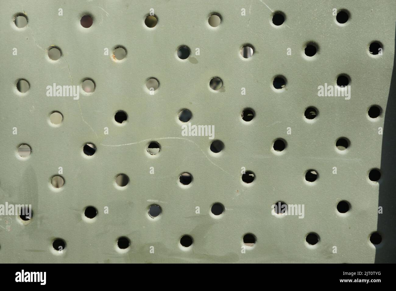 Lattice texture close up. Holes of grey metal plate with round regular ...