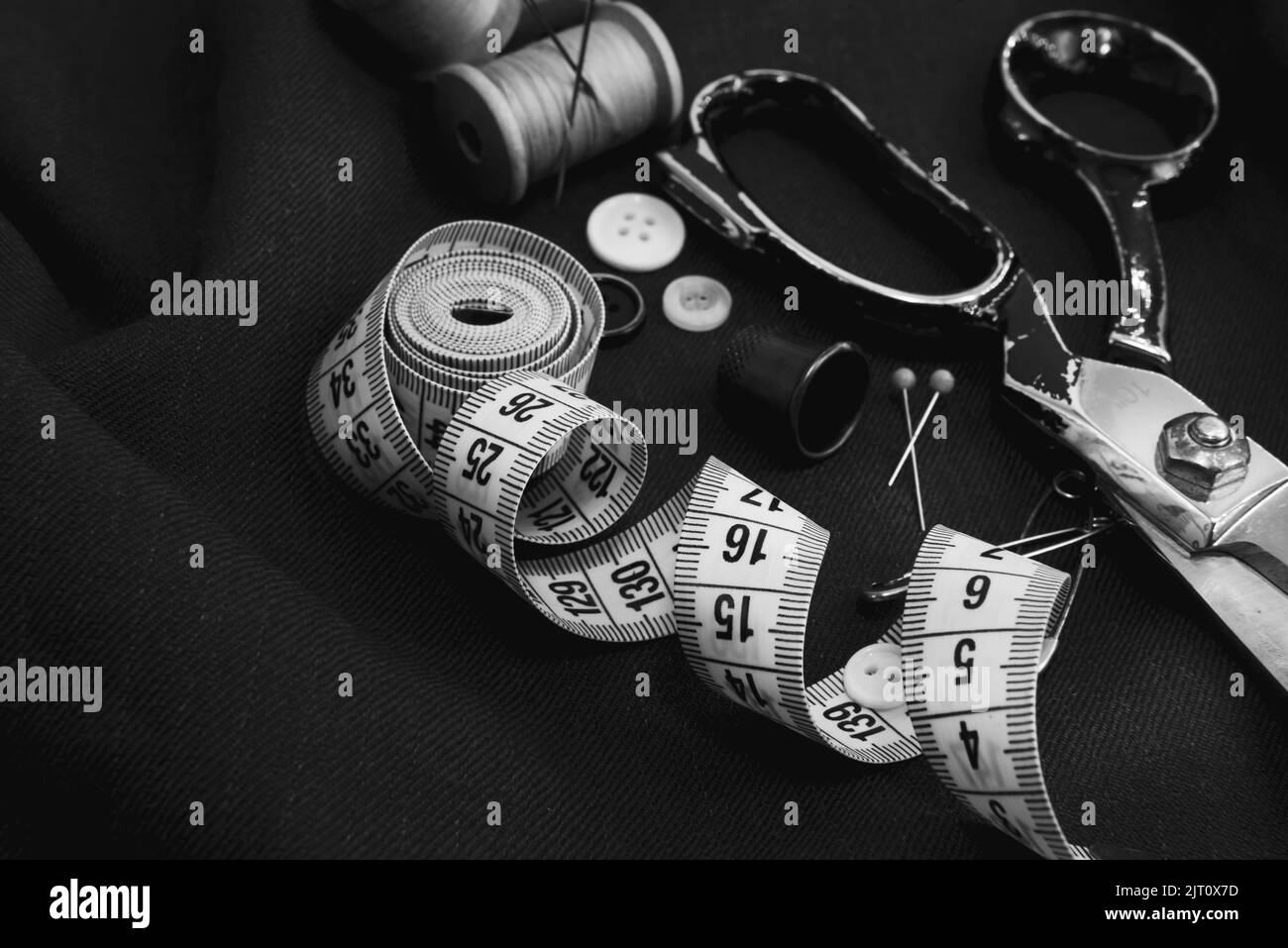 Retro tools for cutting and sewing. Needle with thread, thimble, sewing ...