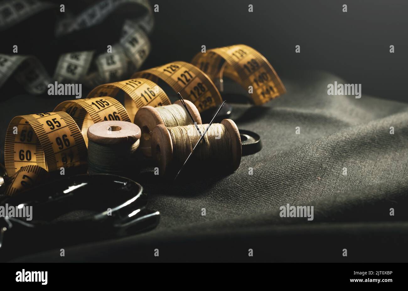 Retro tools for cutting and sewing. Needle with thread, thimble, sewing ...