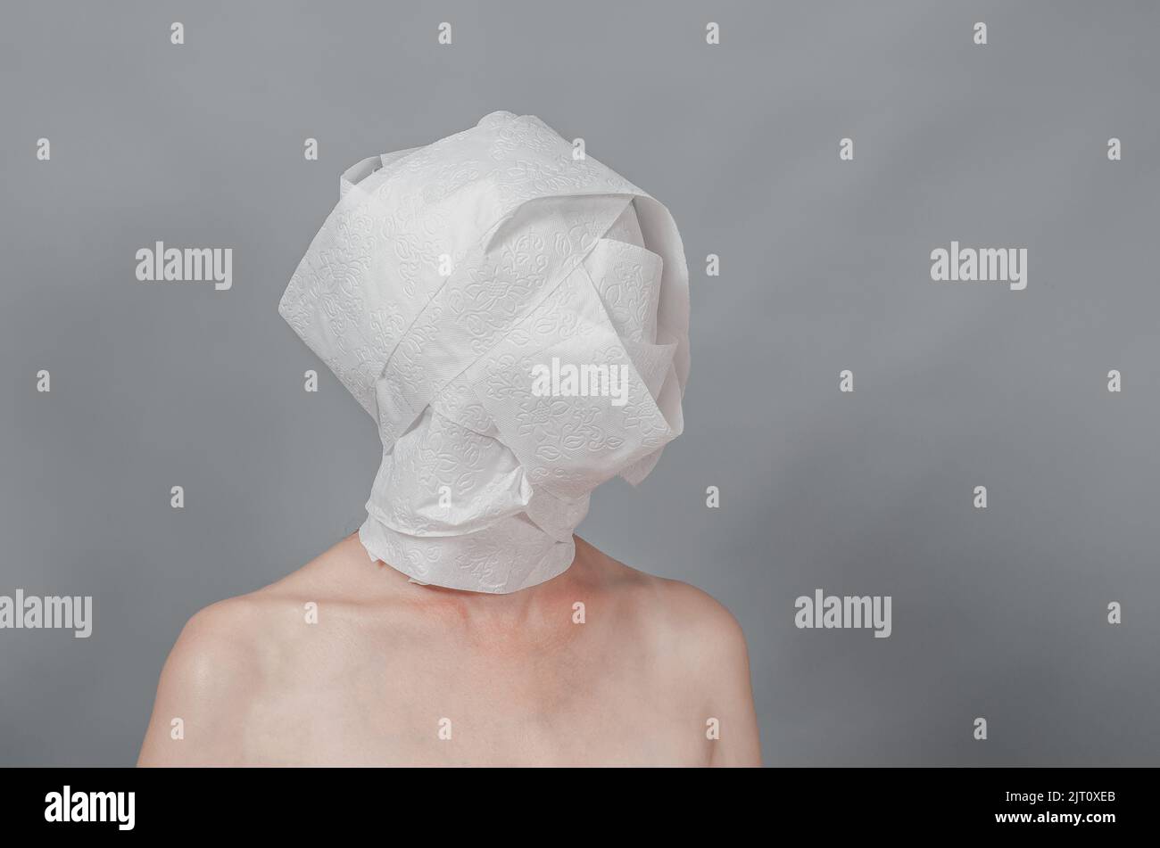 Woman's head wrapped in white tissue paper. Symbol of loneliness and ...