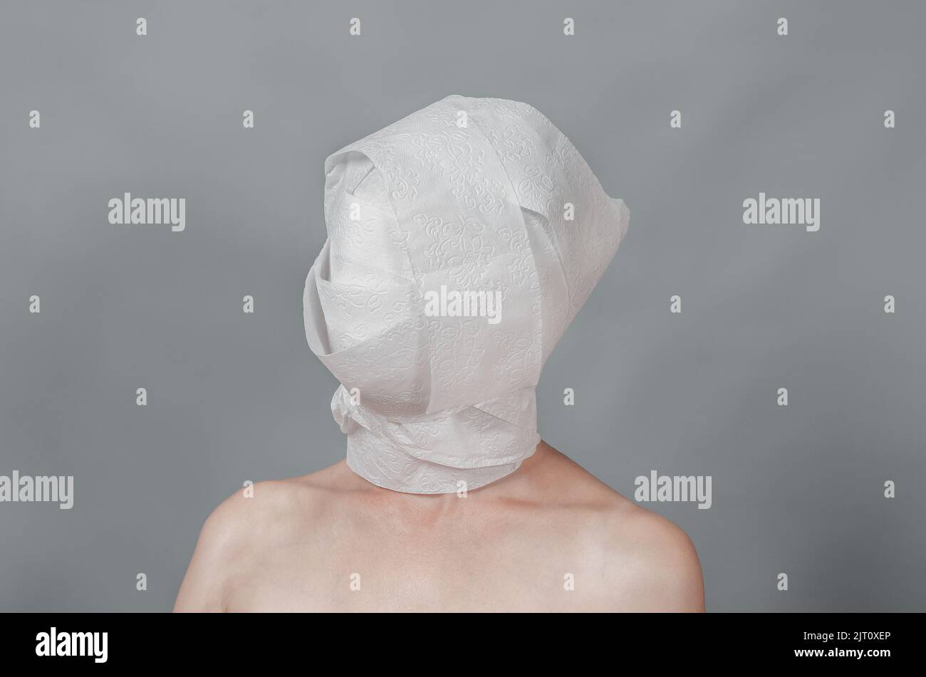 Woman's head wrapped in white tissue paper. Symbol of loneliness and ...