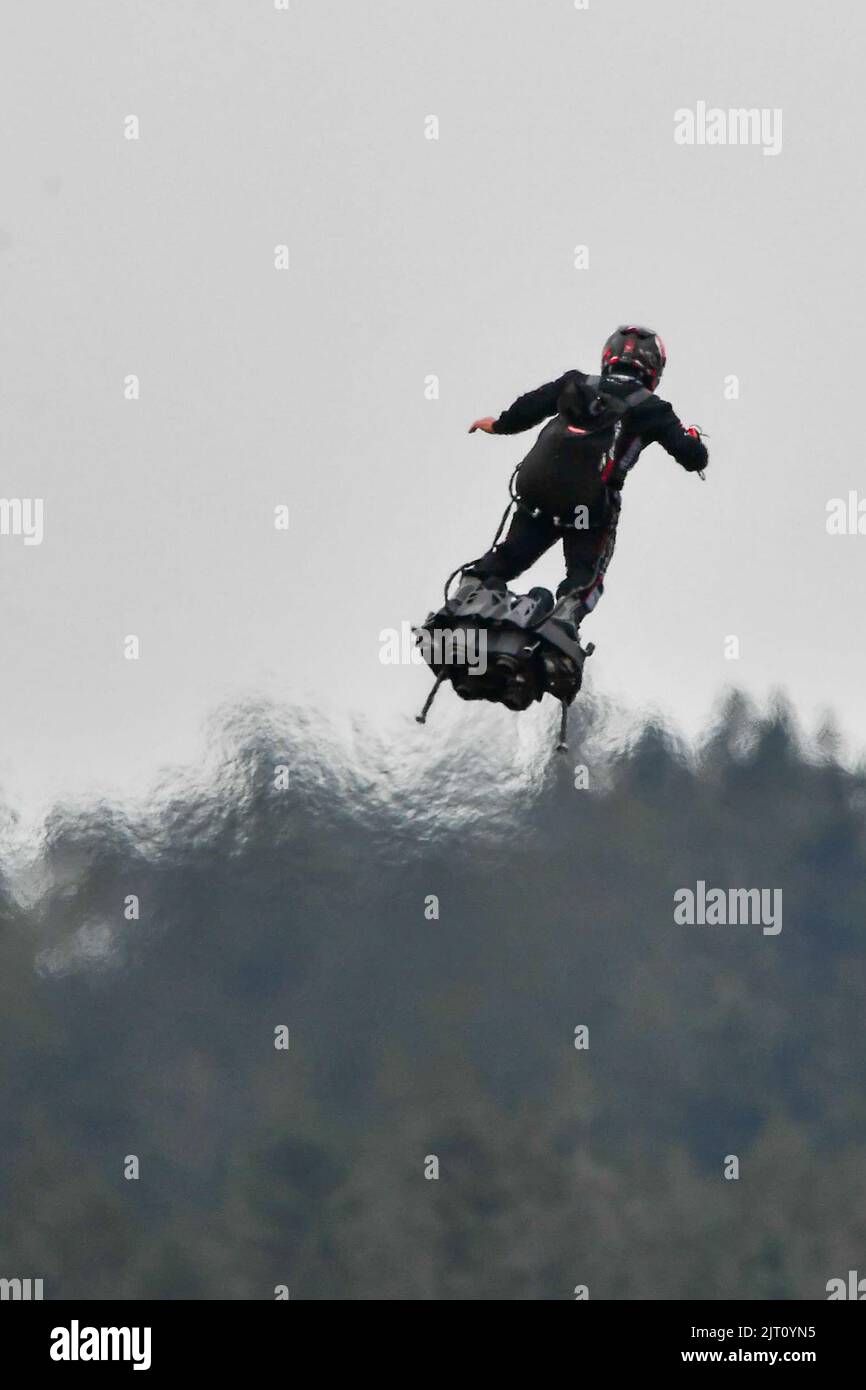 A man is seen flying on a jet-powered hoverboard ahead of the third ...