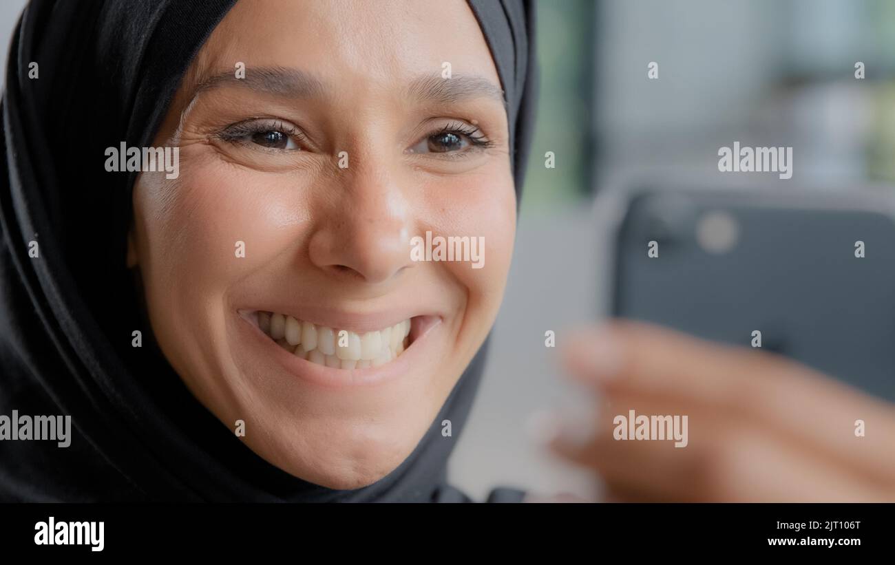 Headshot young pretty happy arab woman in hijab smiling with white ...