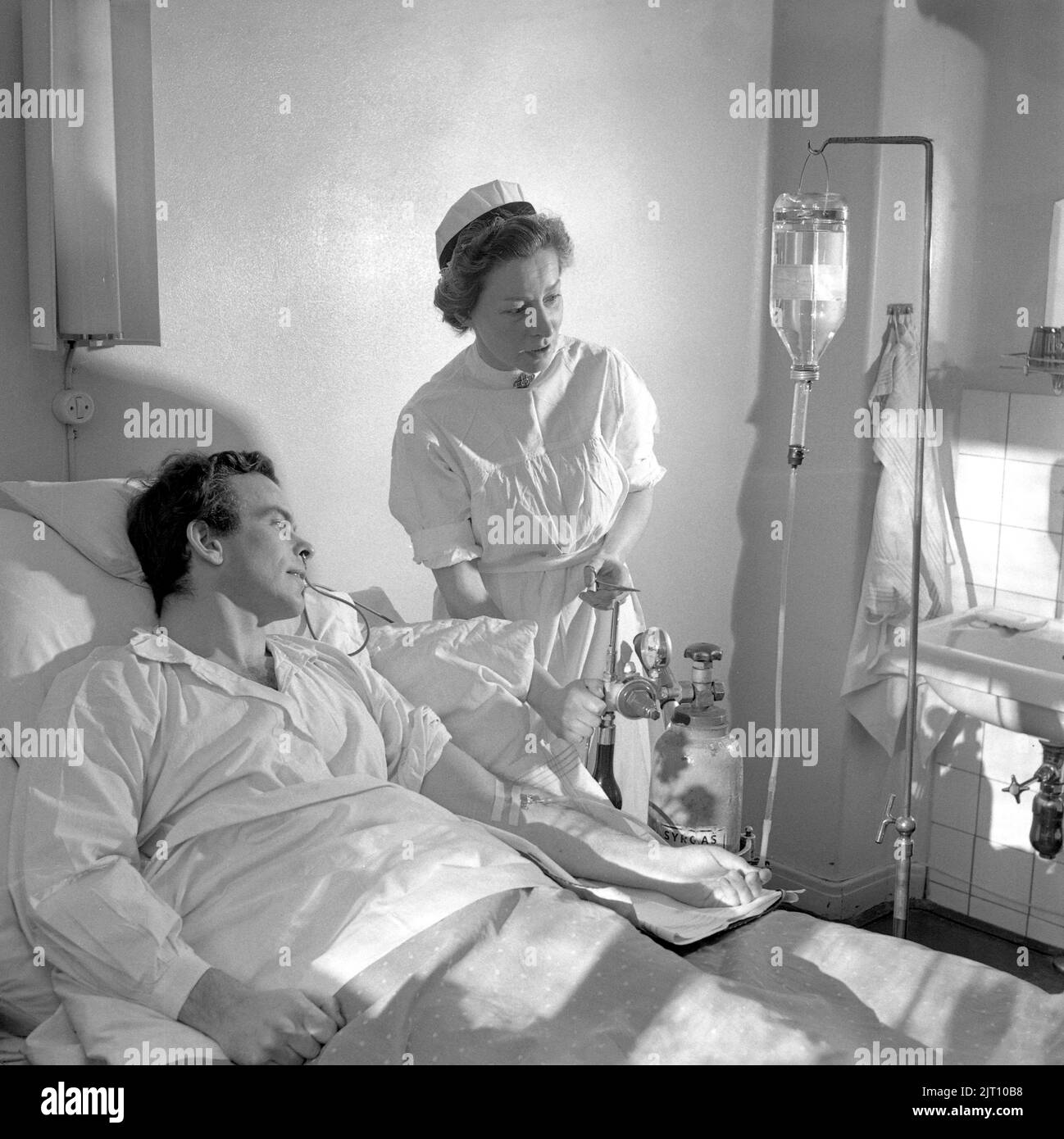 Hospital in the 1950s. A nurse adjusts the oxygen that is given to the ...