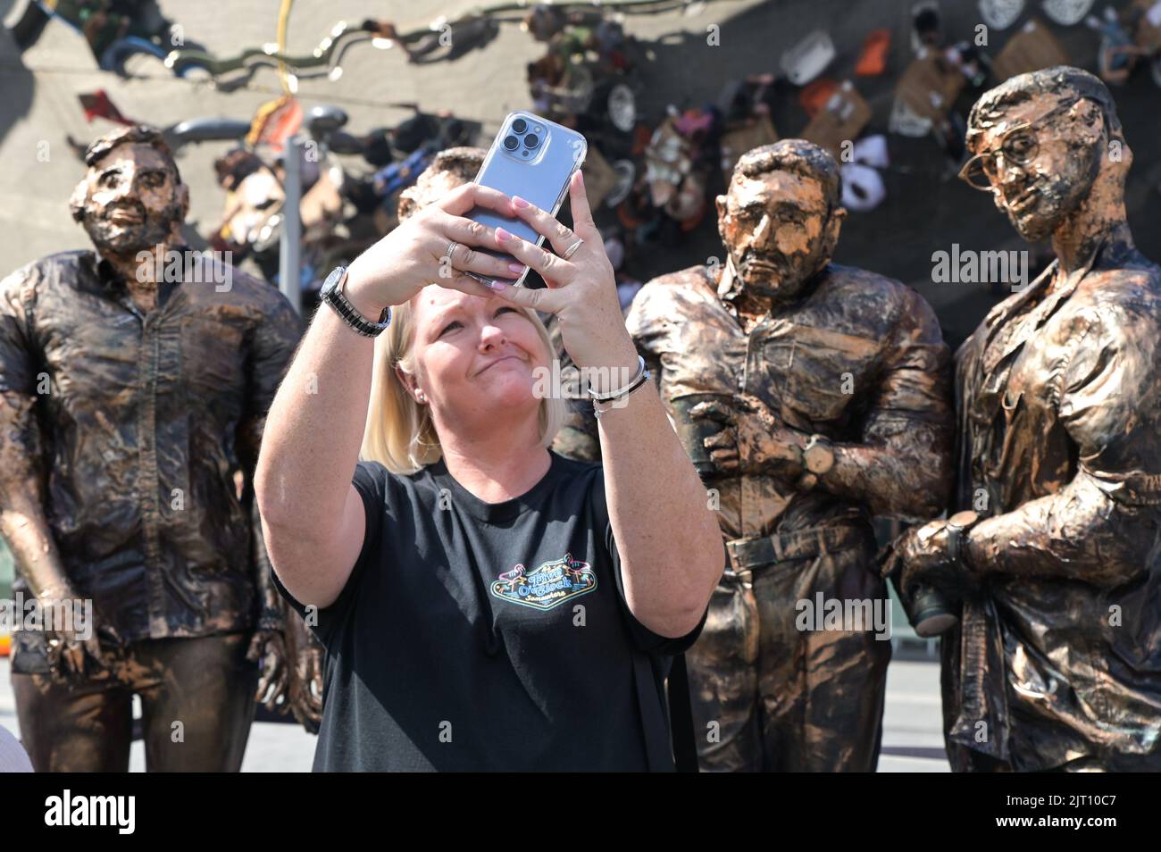 Four lads in jeans statue hi-res stock photography and images - Alamy