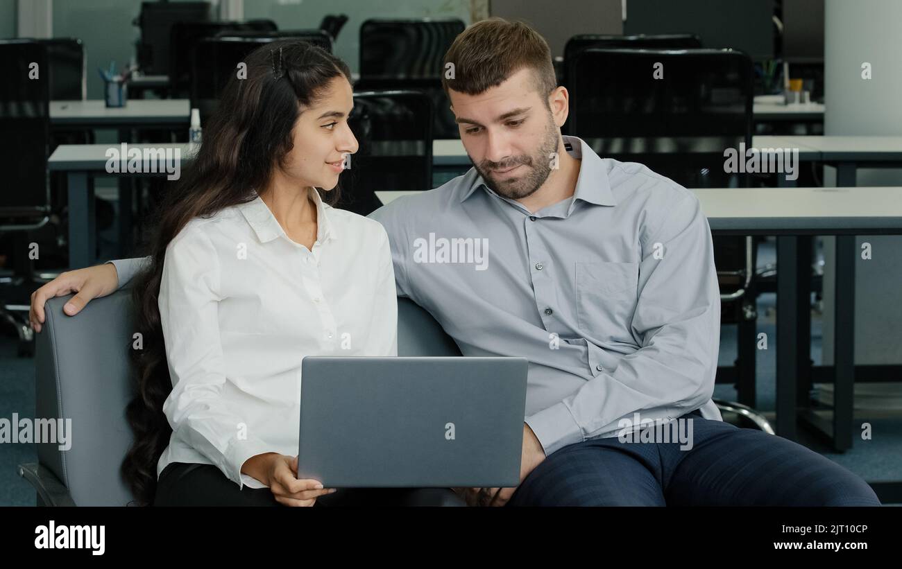 Friendly colleagues communicate sitting in office promising young woman ...