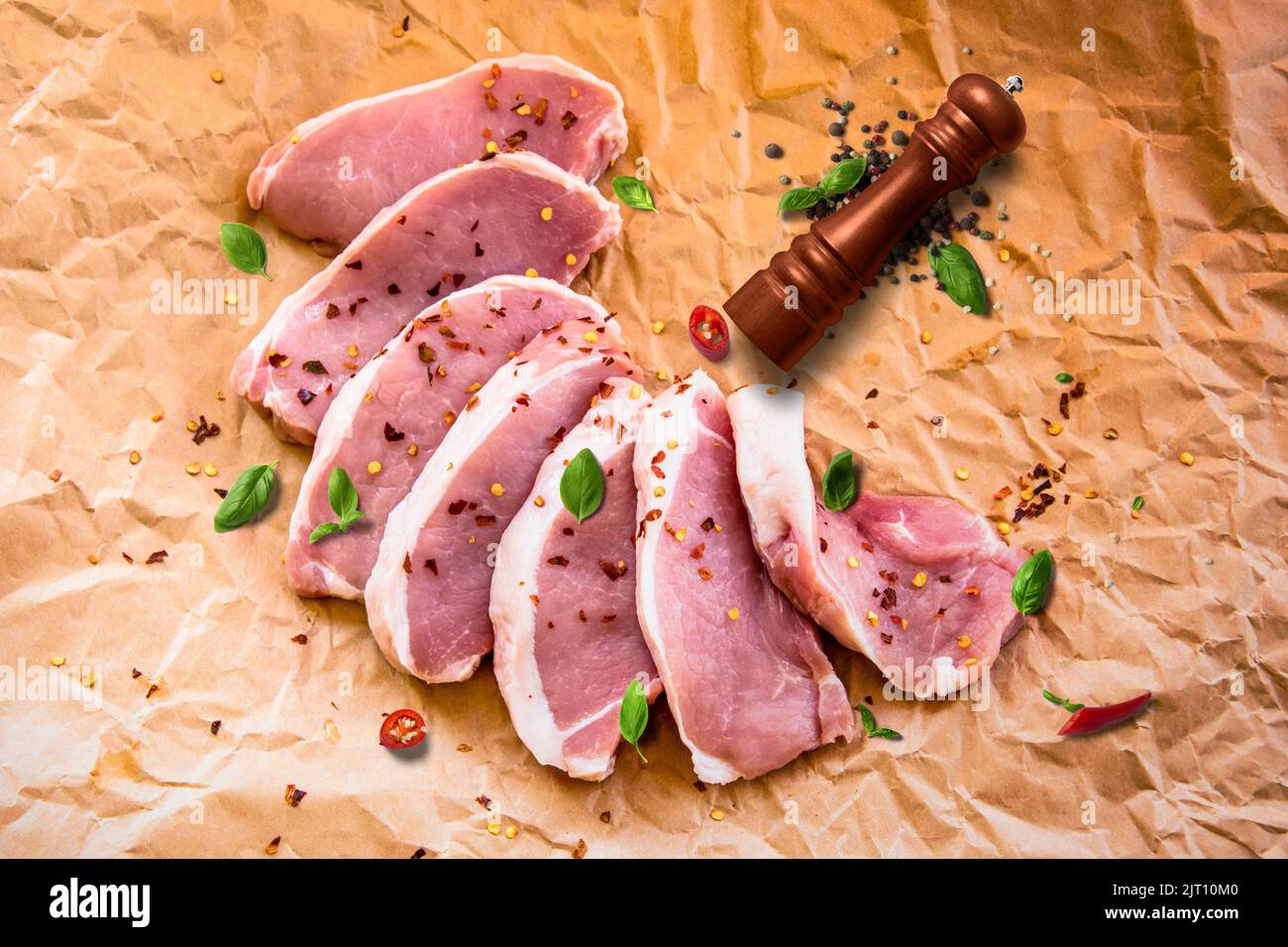 Fresh raw pork chops on a cutting board. Arrangement on the wrapping ...