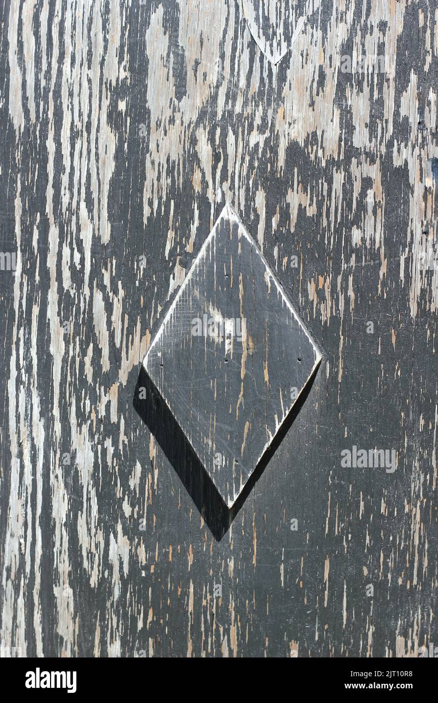 Simple diamond shape cut out of a plank of wood as decoration for a ...