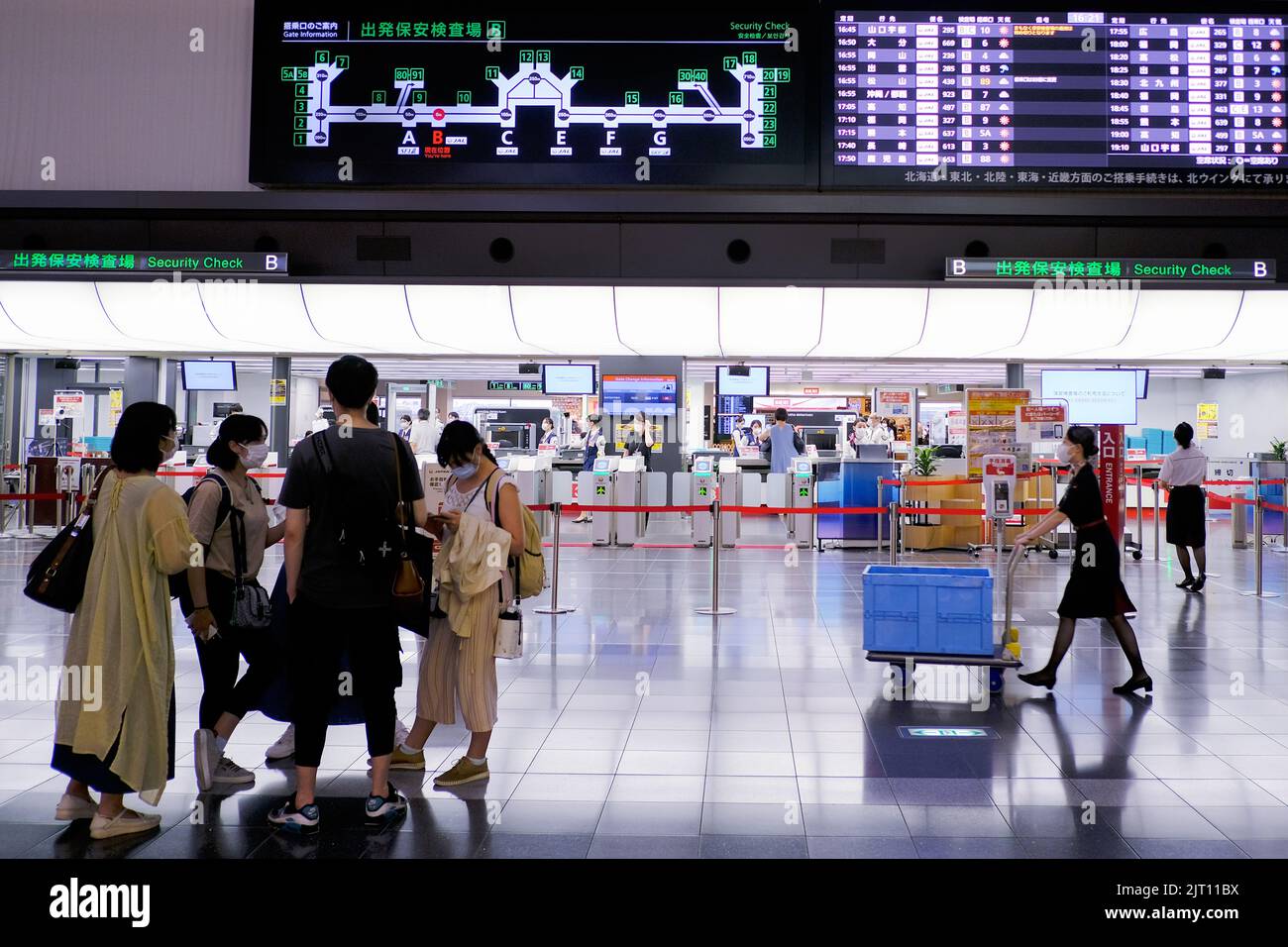 An employee of Japan Airlines (JAL) wearing a face mask as a preventive ...