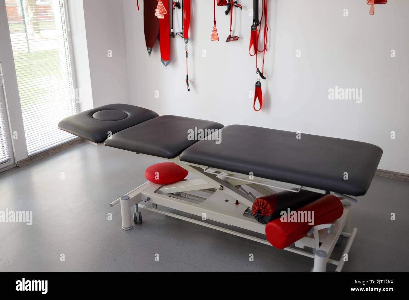 Physiotherapist's office with suspension therapy system red cord for ...
