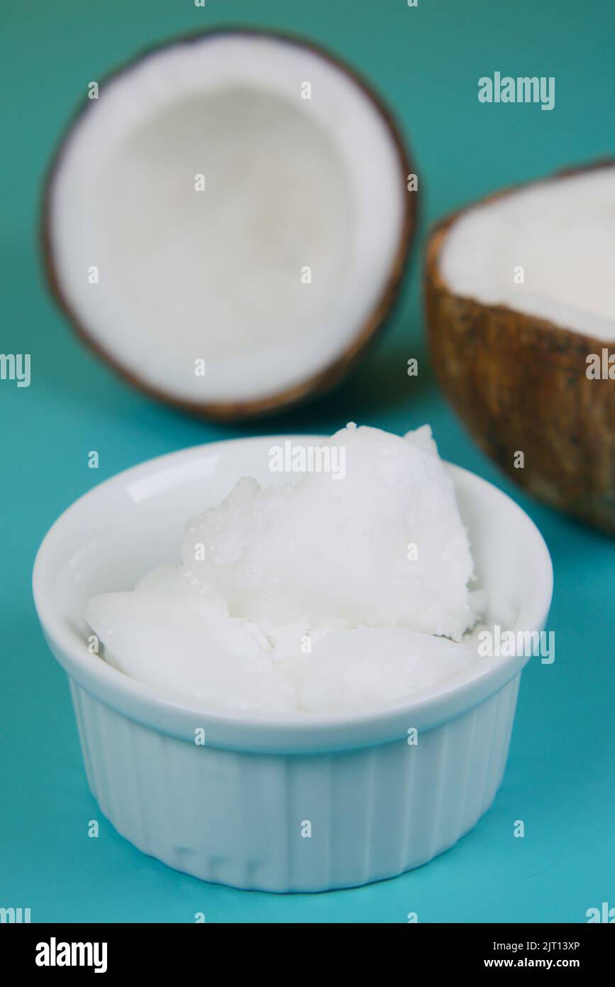 cold coconut oil in a small jar and fresh coconut on table Stock Photo ...