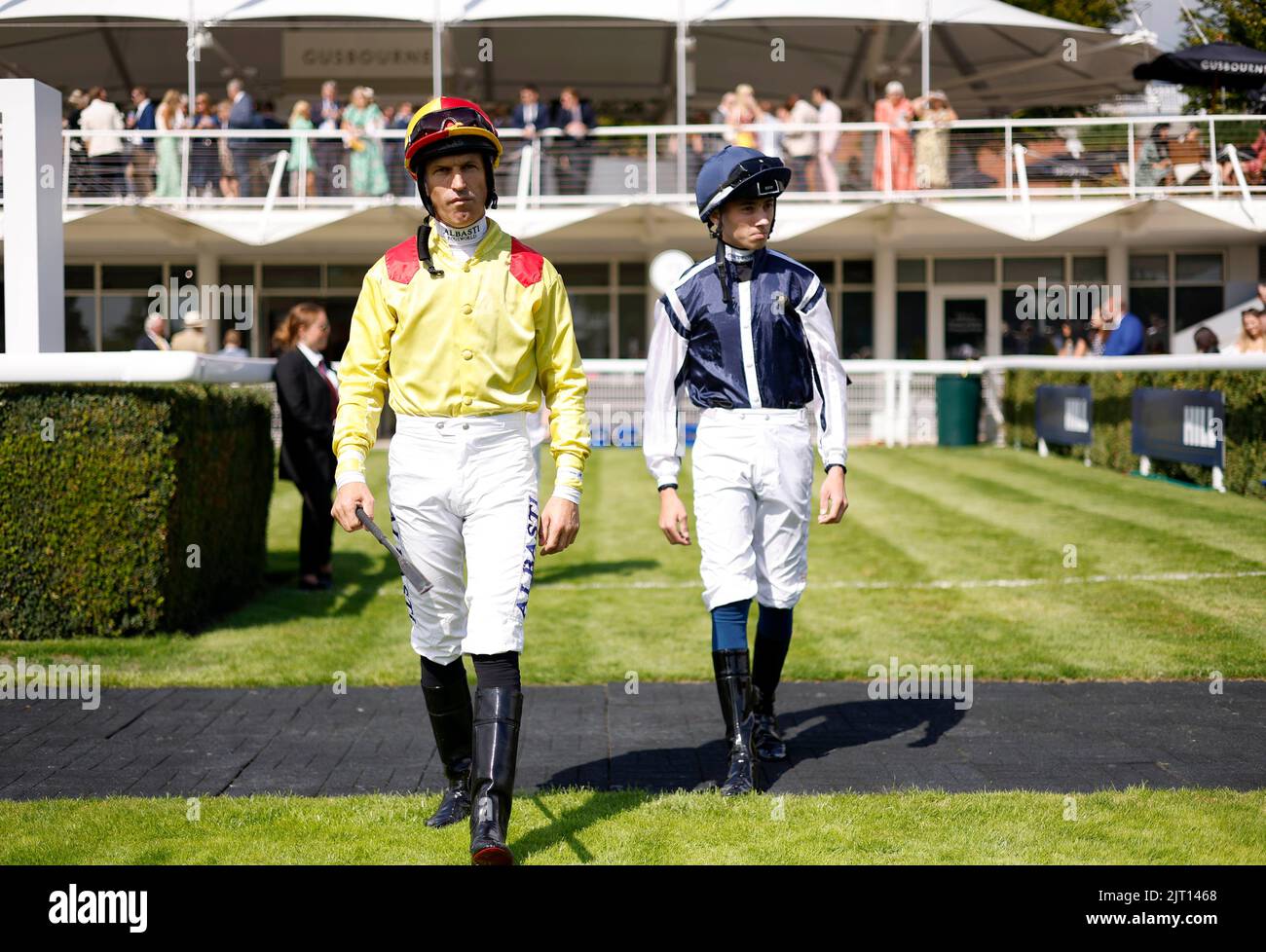 Jockey Pat Dobbs (left) and jockey Callum Hutchinson make their way out ...
